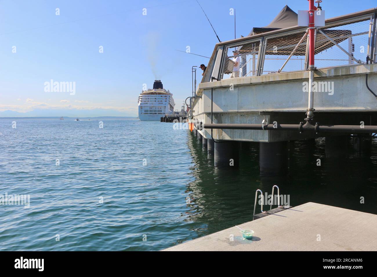 People fishing from Pier 62 with distant Bay Lady schooner fast moving ...