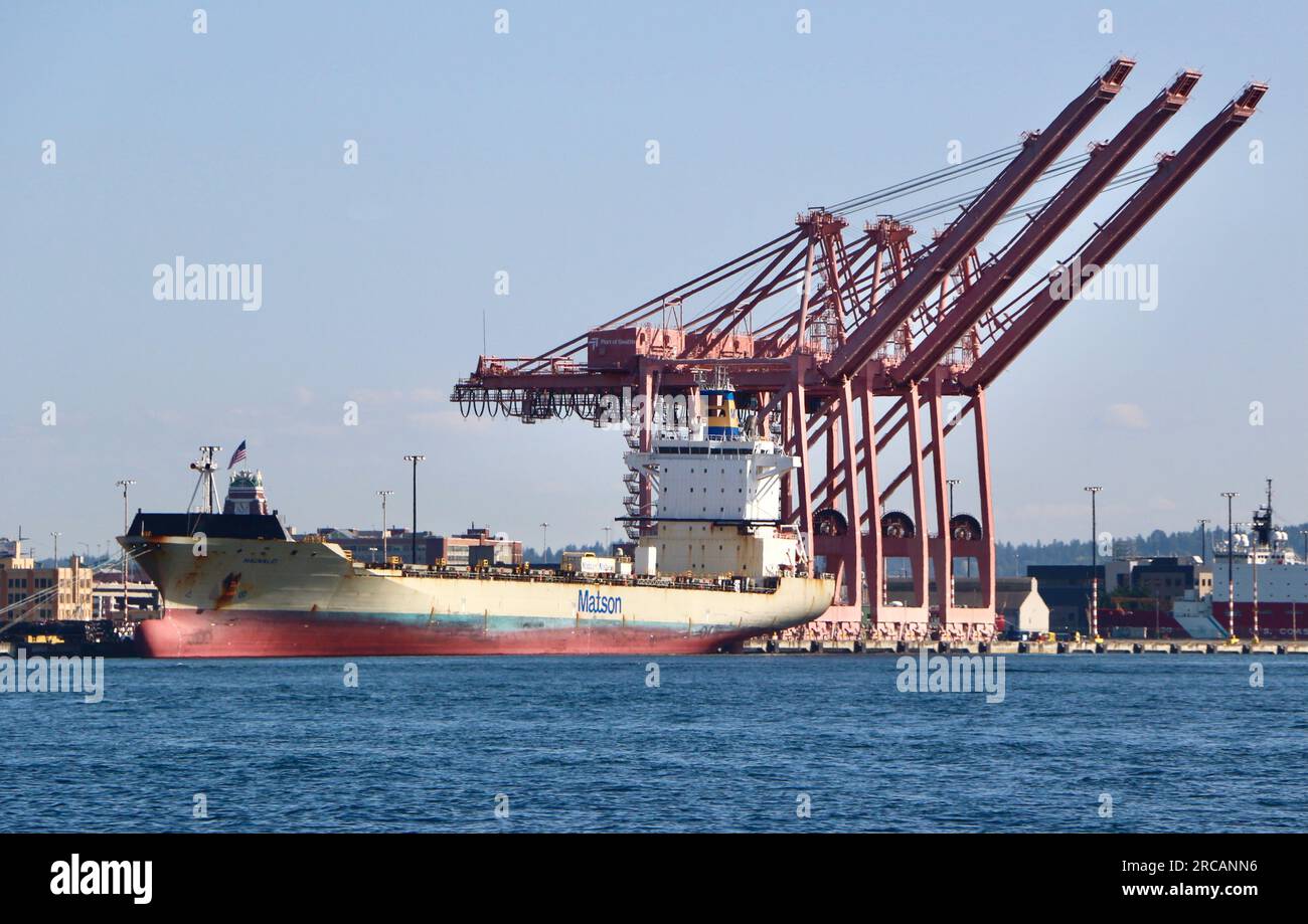 Container Ship Maunalei moored at the dockside dwarfed by huge cranes ...