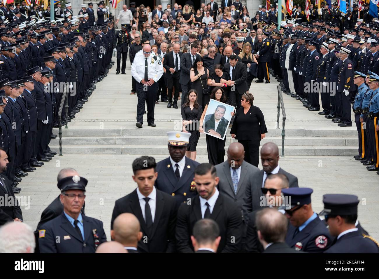 Family and close friends walk behind the casket of Newark firefighter ...