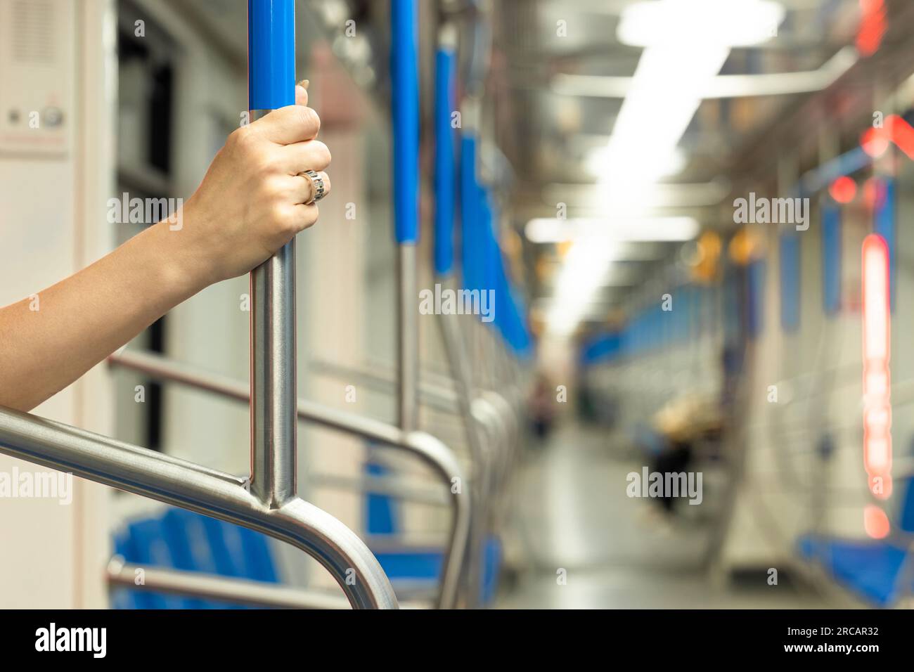 Woman holding hand on handrail in subway car. hand holding the railing ...