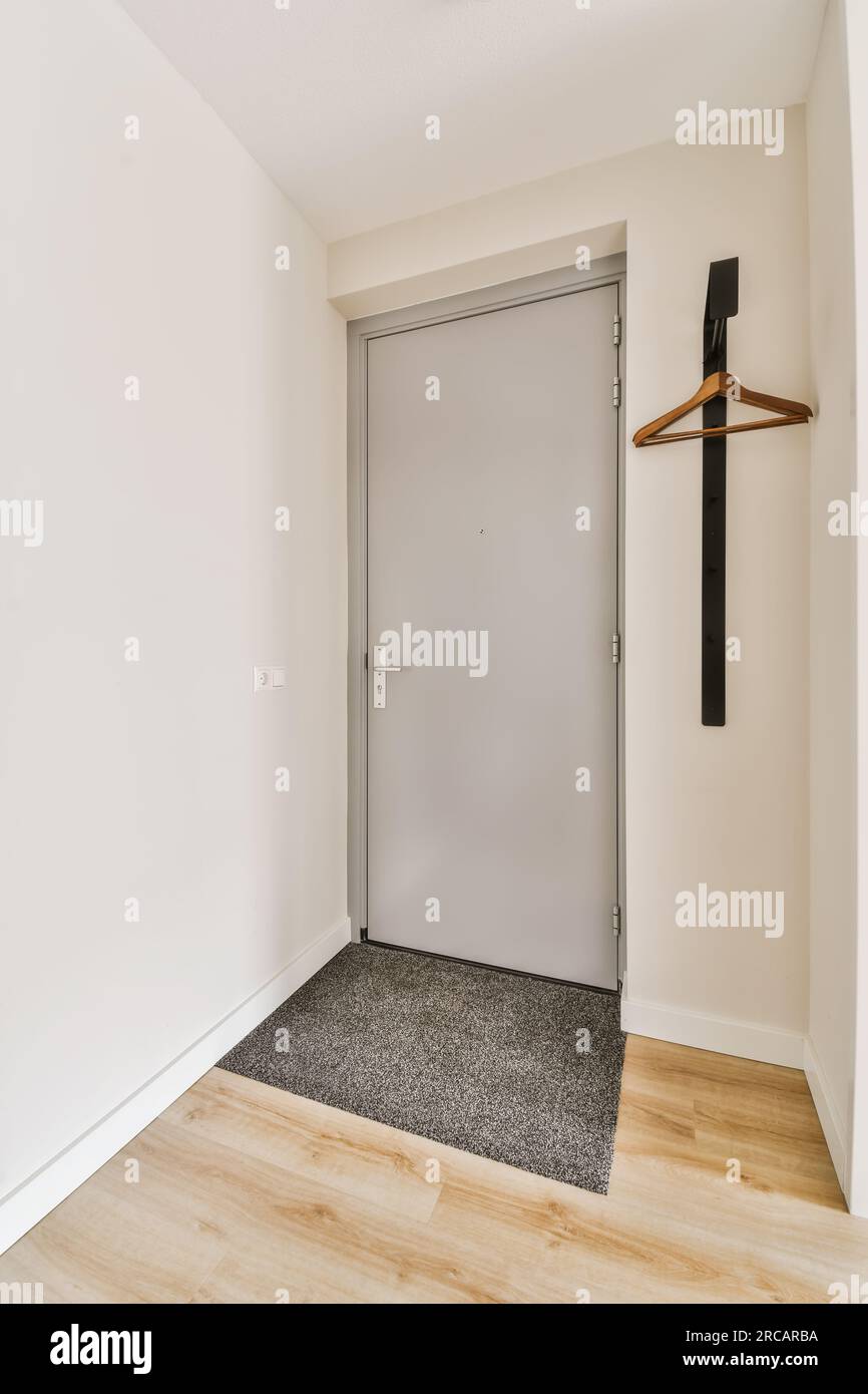 an empty room with white walls and wood flooring the door is open on ...