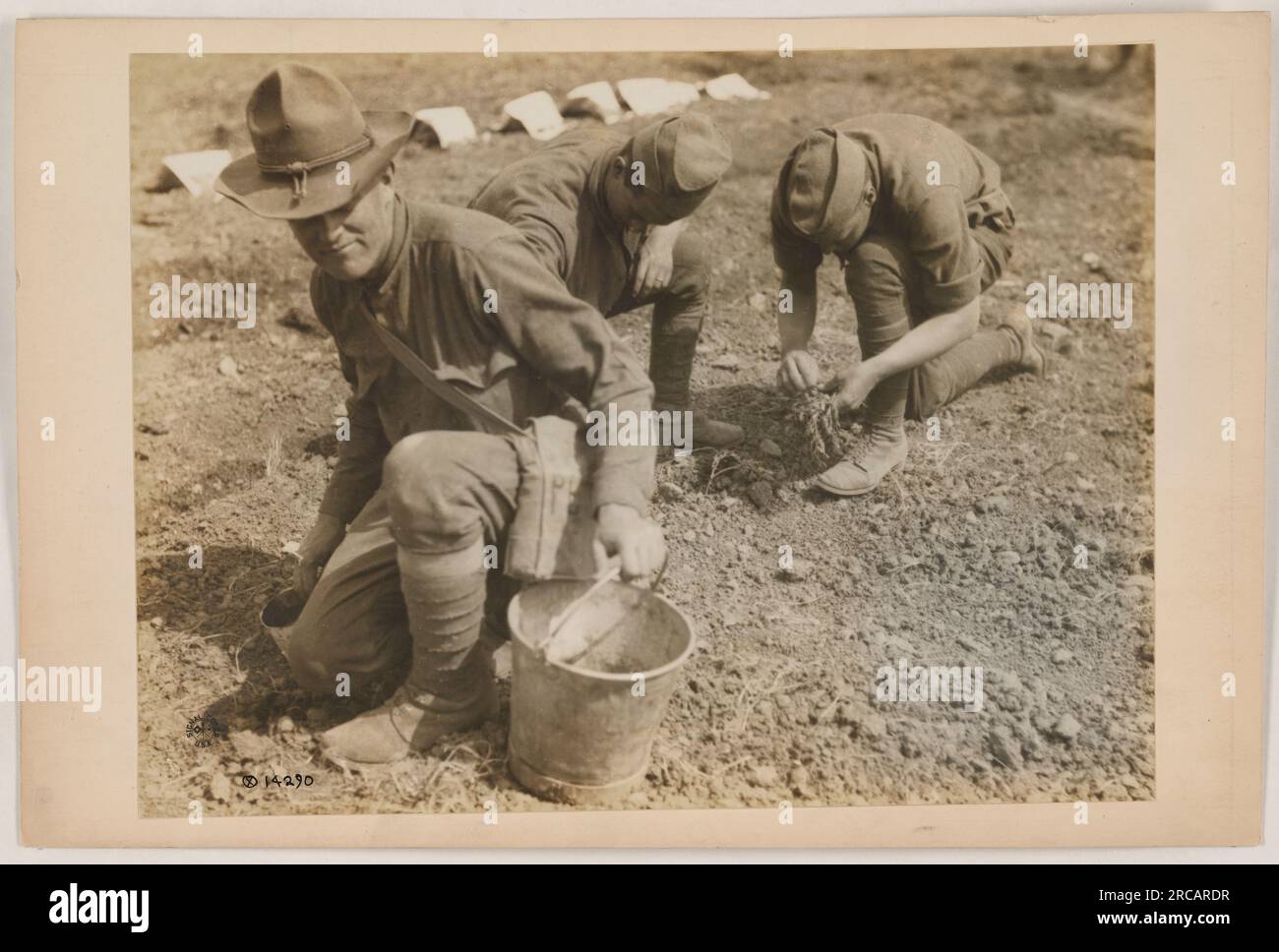 "Soldiers preparing to load artillery shells onto a military truck ...