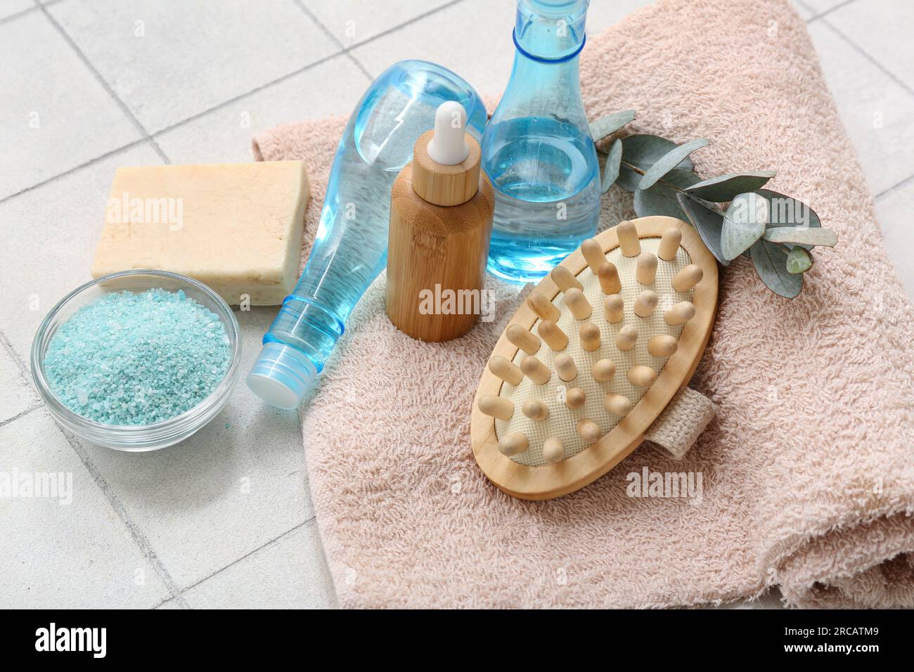 Set of bath supplies and cosmetic products on light tile background ...