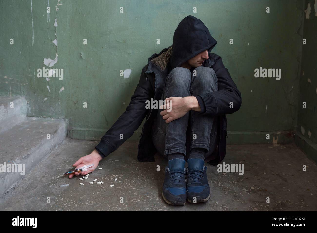 Addiction concept. Addict in crisis in an abandoned house. Overdose ...