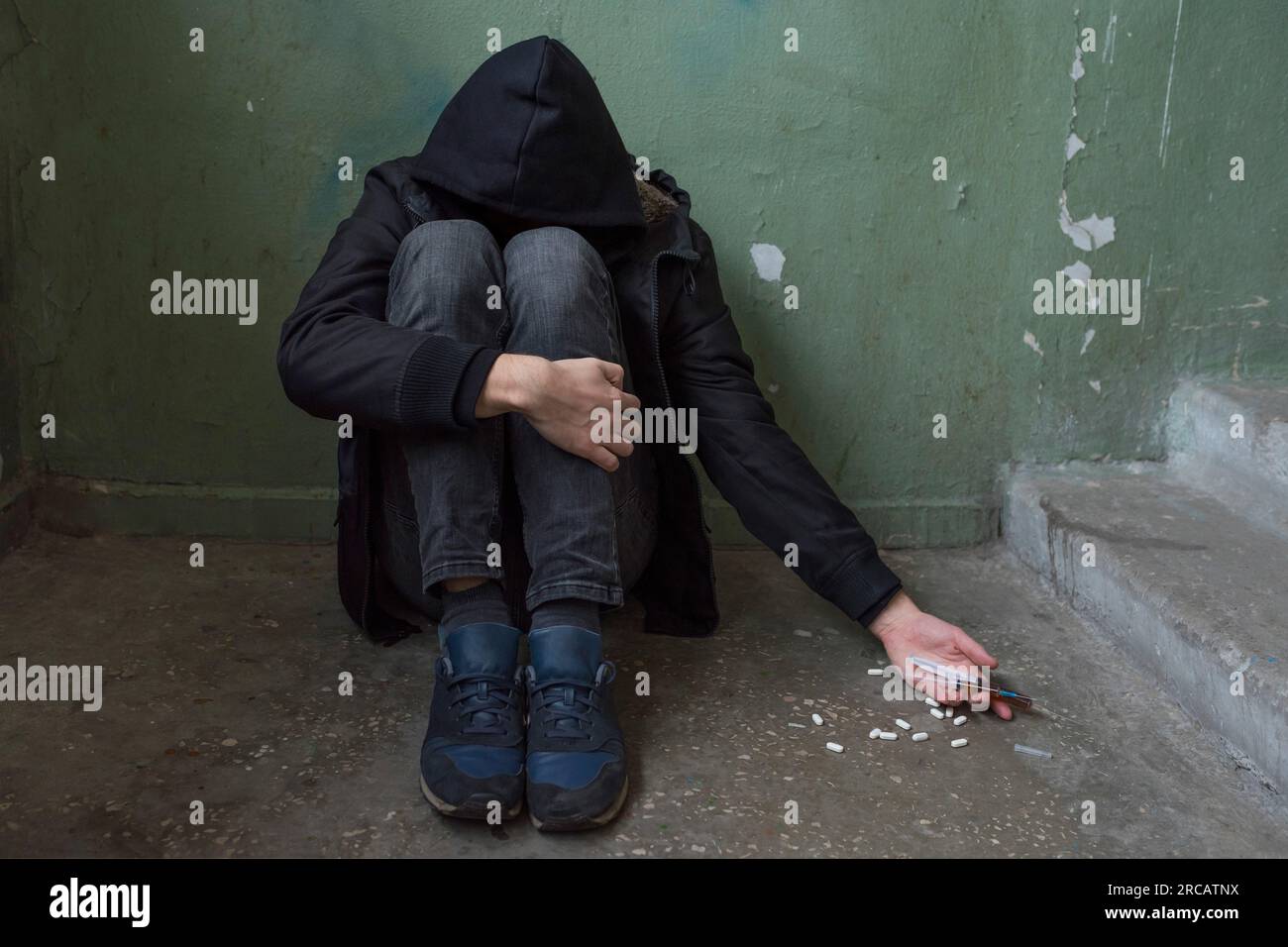 A male drug addict experiencing a drug addiction crisis after prolonged ...