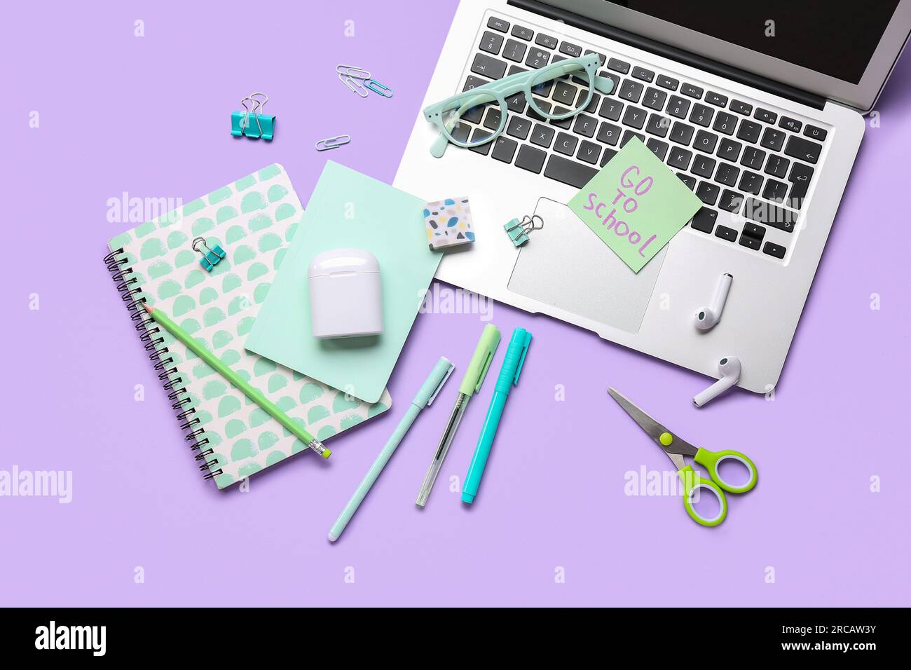 Sticky note with text GO TO SCHOOL, different stationery, laptop and ...