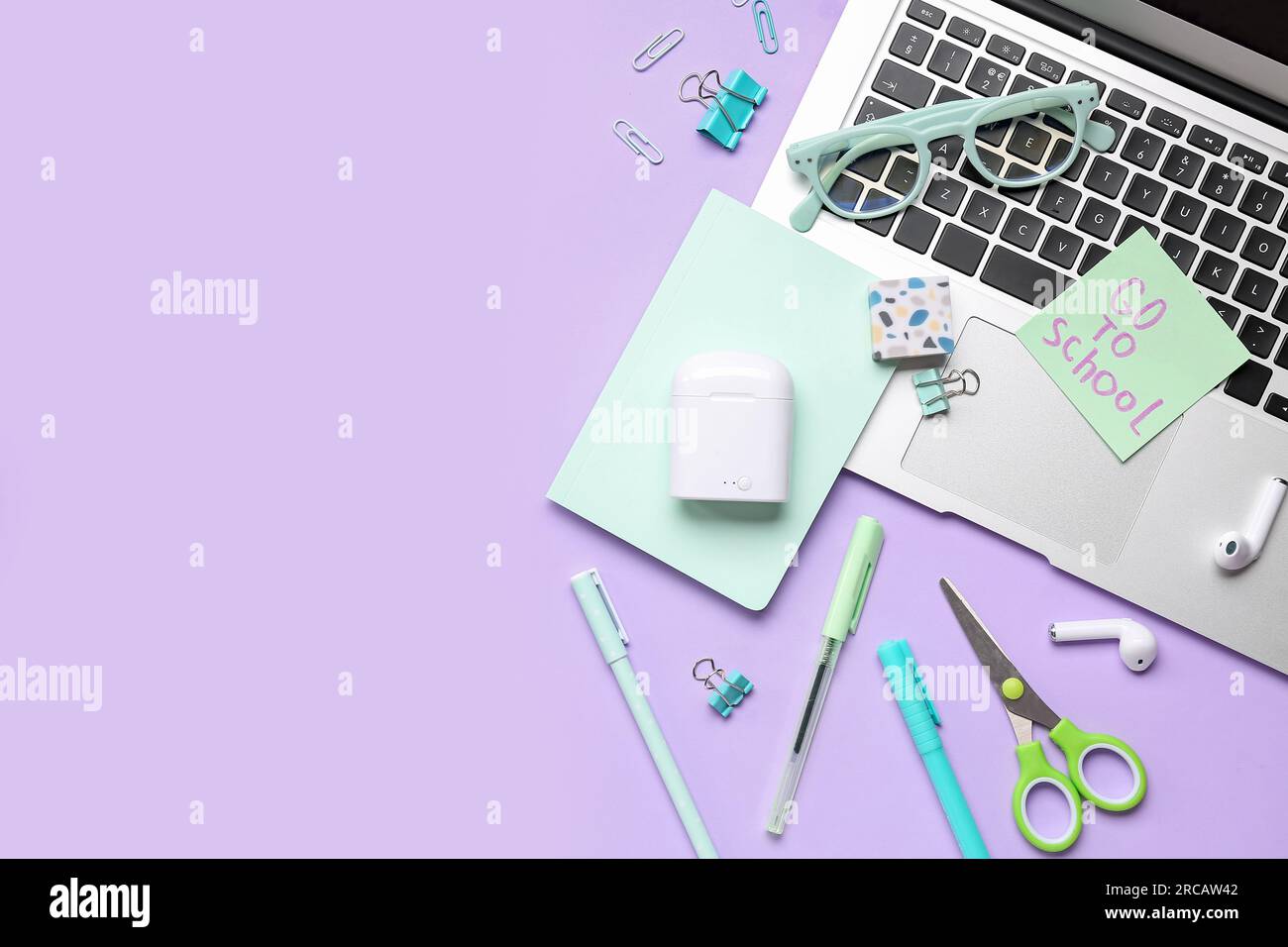 Sticky note with text GO TO SCHOOL, different stationery, laptop and ...