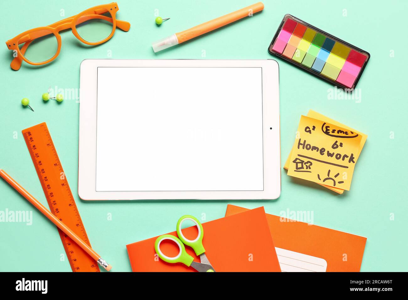 Sticky notes with word HOMEWORK, tablet and different stationery on ...