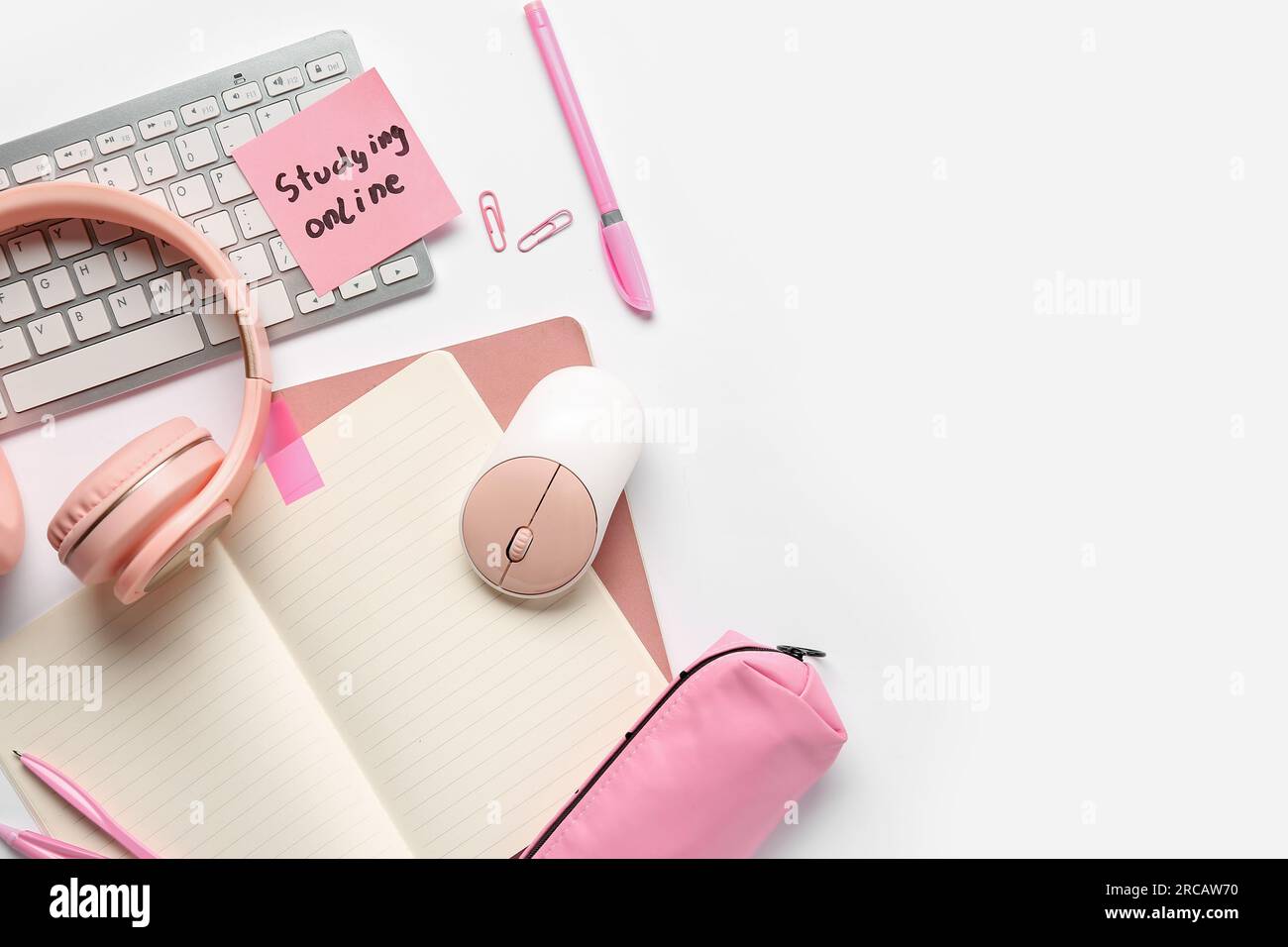 Sticky note with text STUDYING ONLINE, devices and different stationery ...