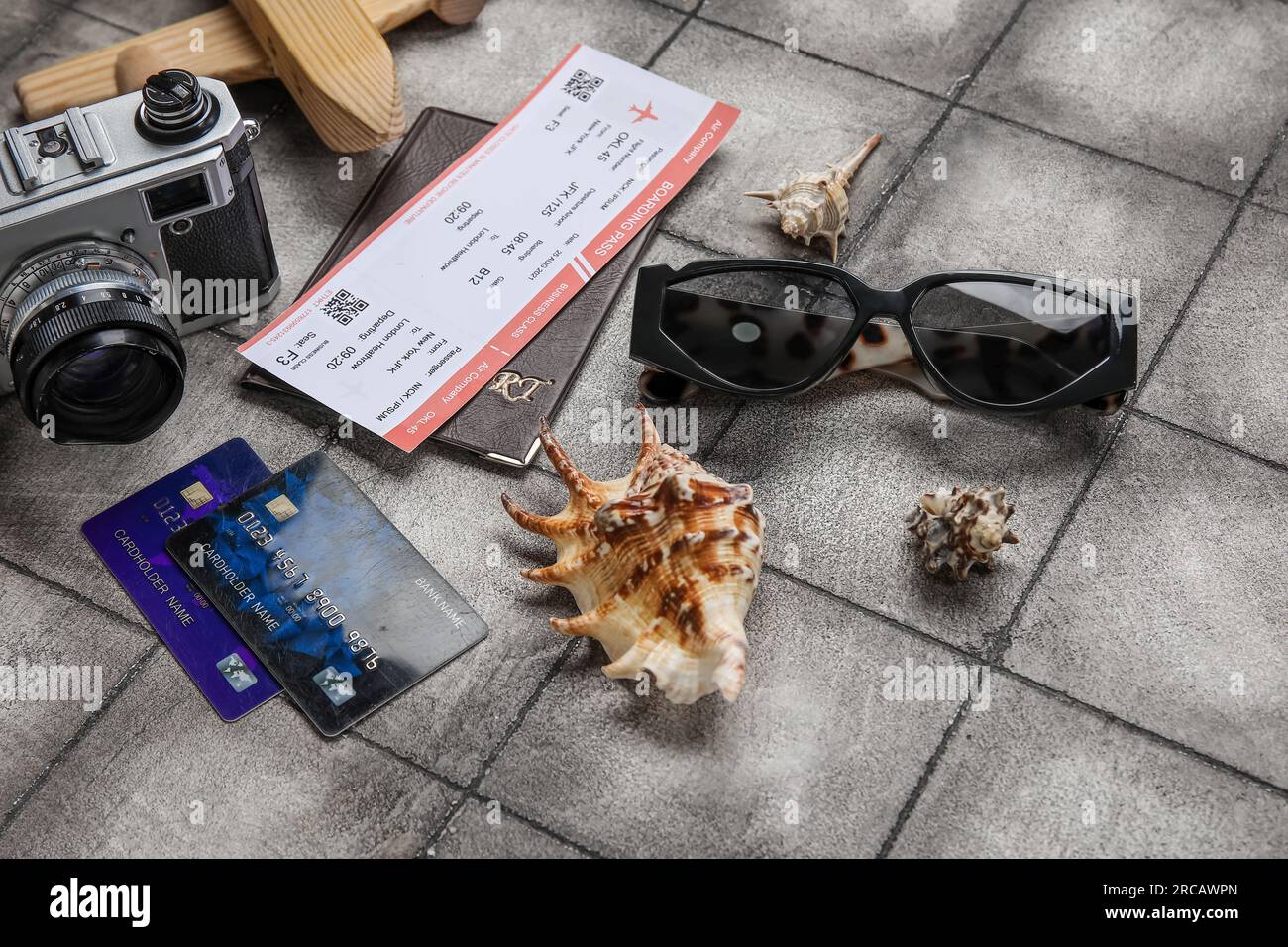 Composition with credit cards, ticket, sunglasses and seashells on ...