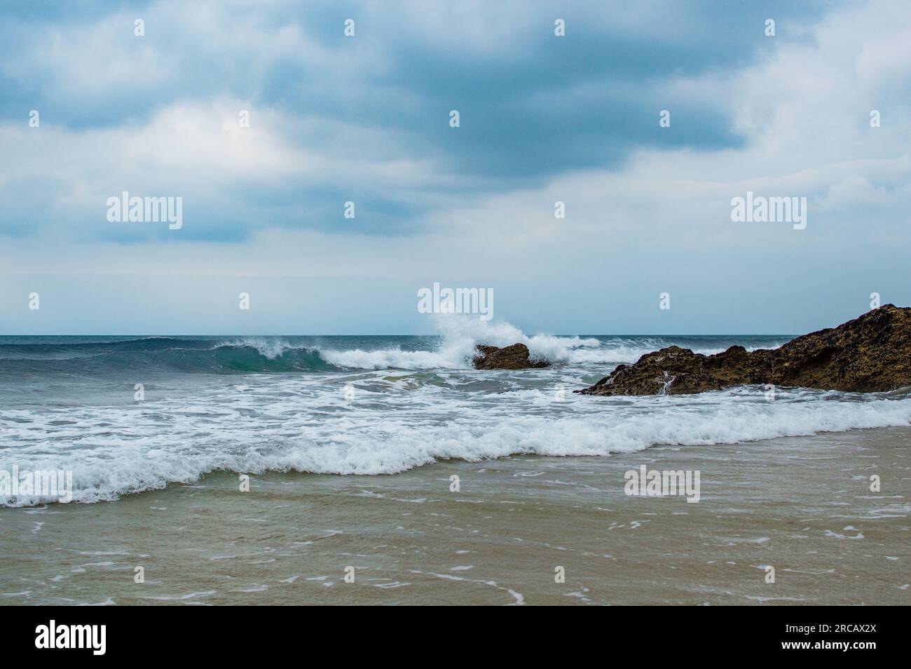 Waves Crashing into a Rock Along the Shore, Cornwall, England, UK Stock ...