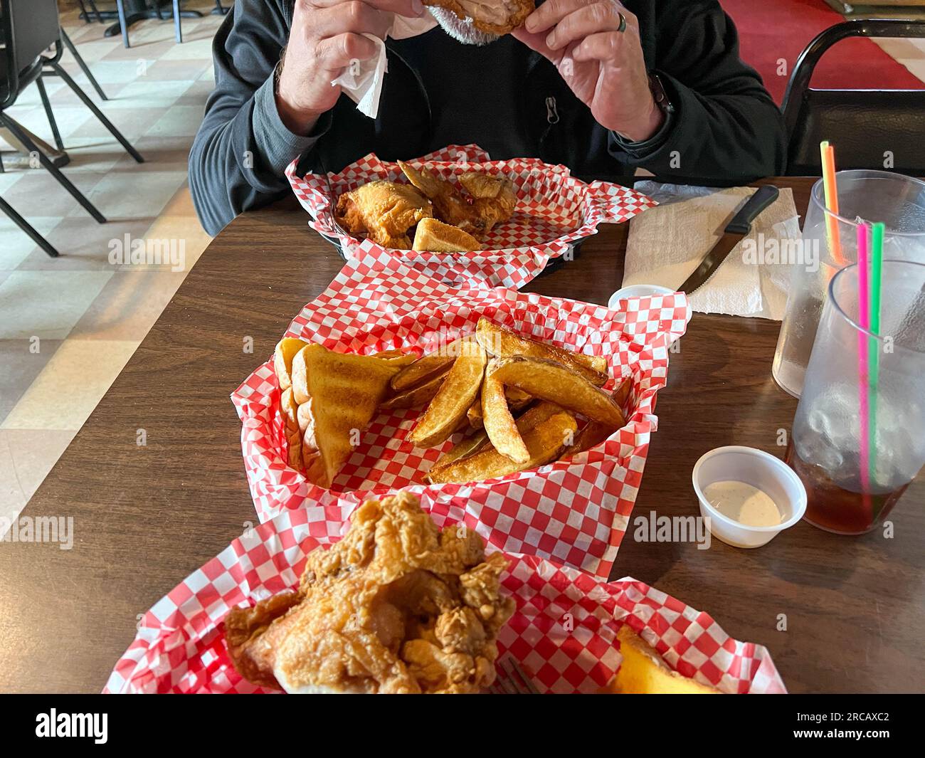 A man eating Fried Chicken at a small town restaurant diner near Libby ...