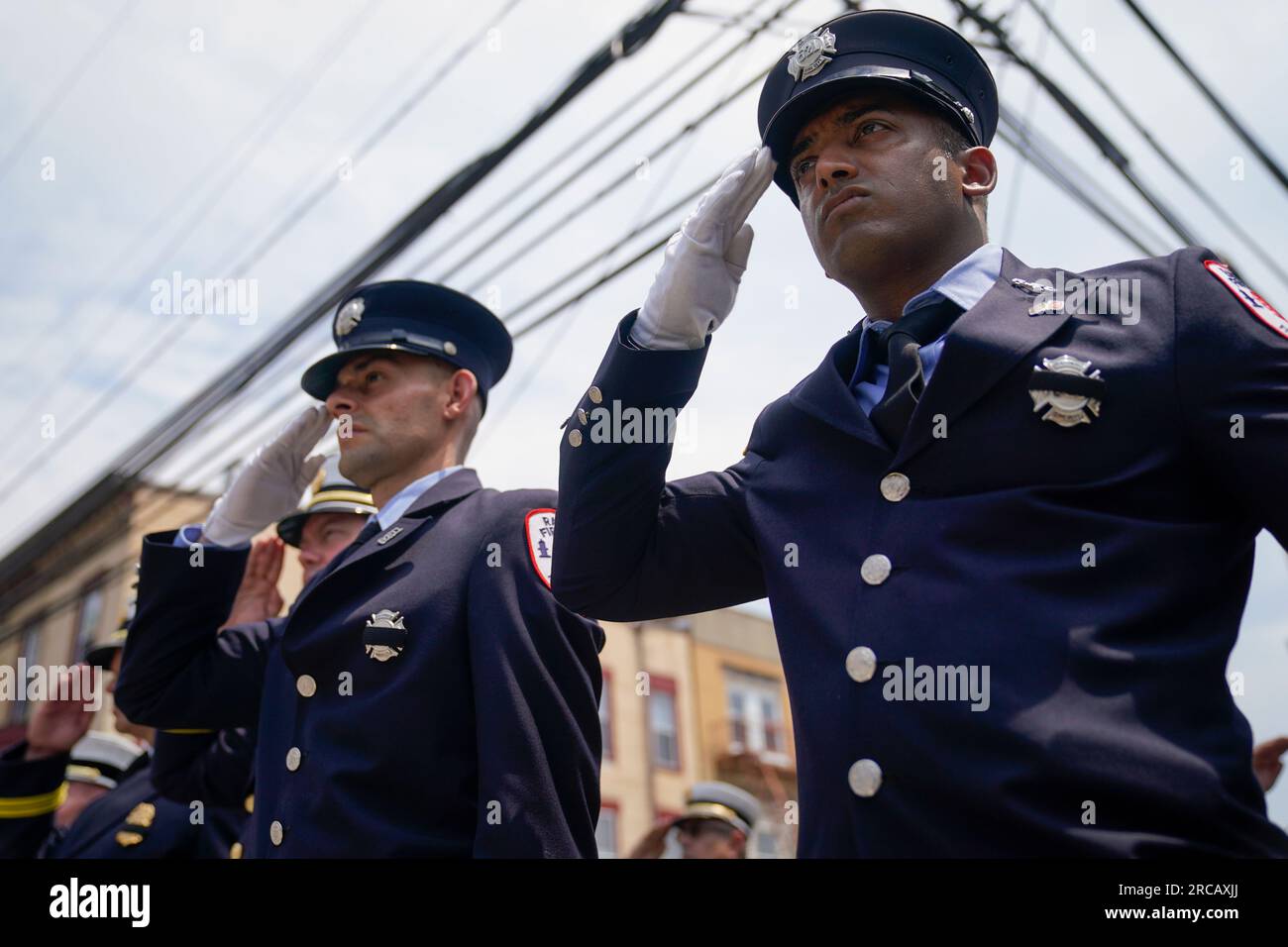 Members of various emergency services salute as the casket of Newark ...