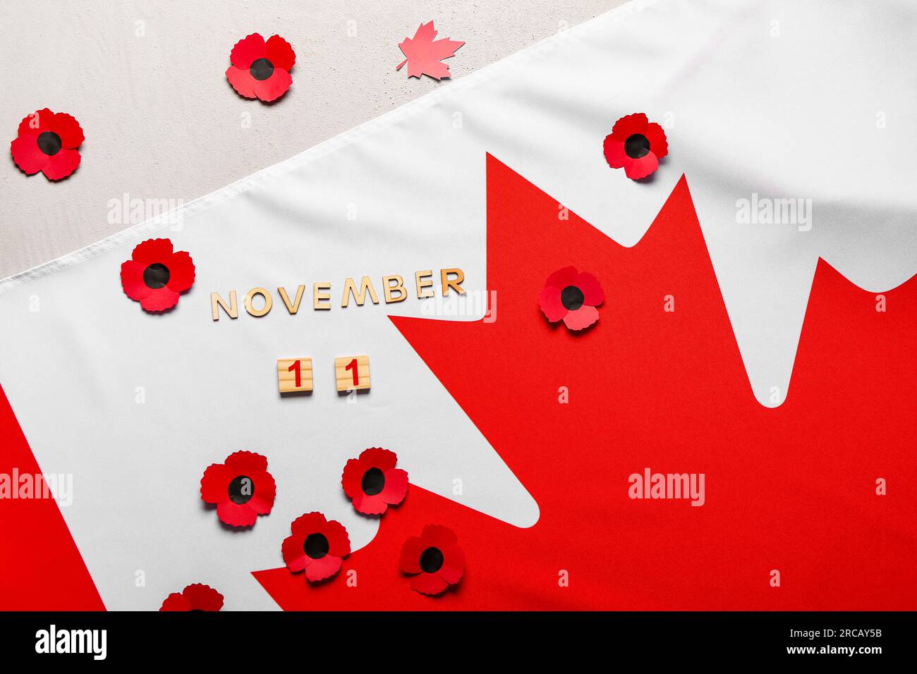 Poppy flowers with flag of Canada and text 11 NOVEMBER on white ...