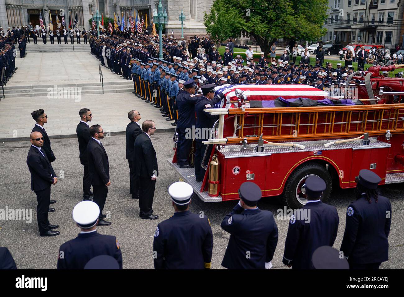 The casket of Newark firefighter Augusto "Augie" Acabou is raised to ...