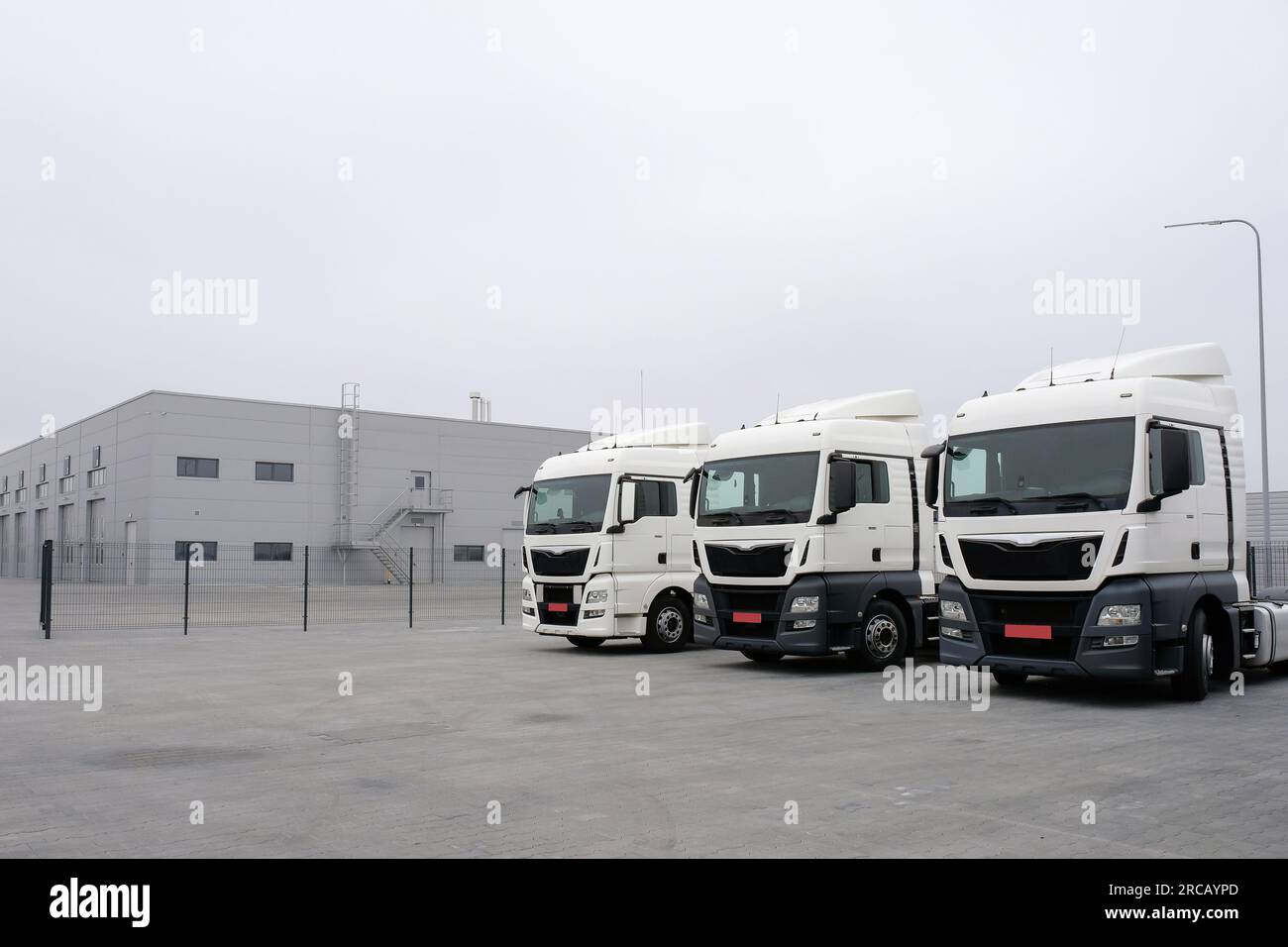 Trucks stand in a row at a truck stop. Cargo semi-trailers for delivery ...