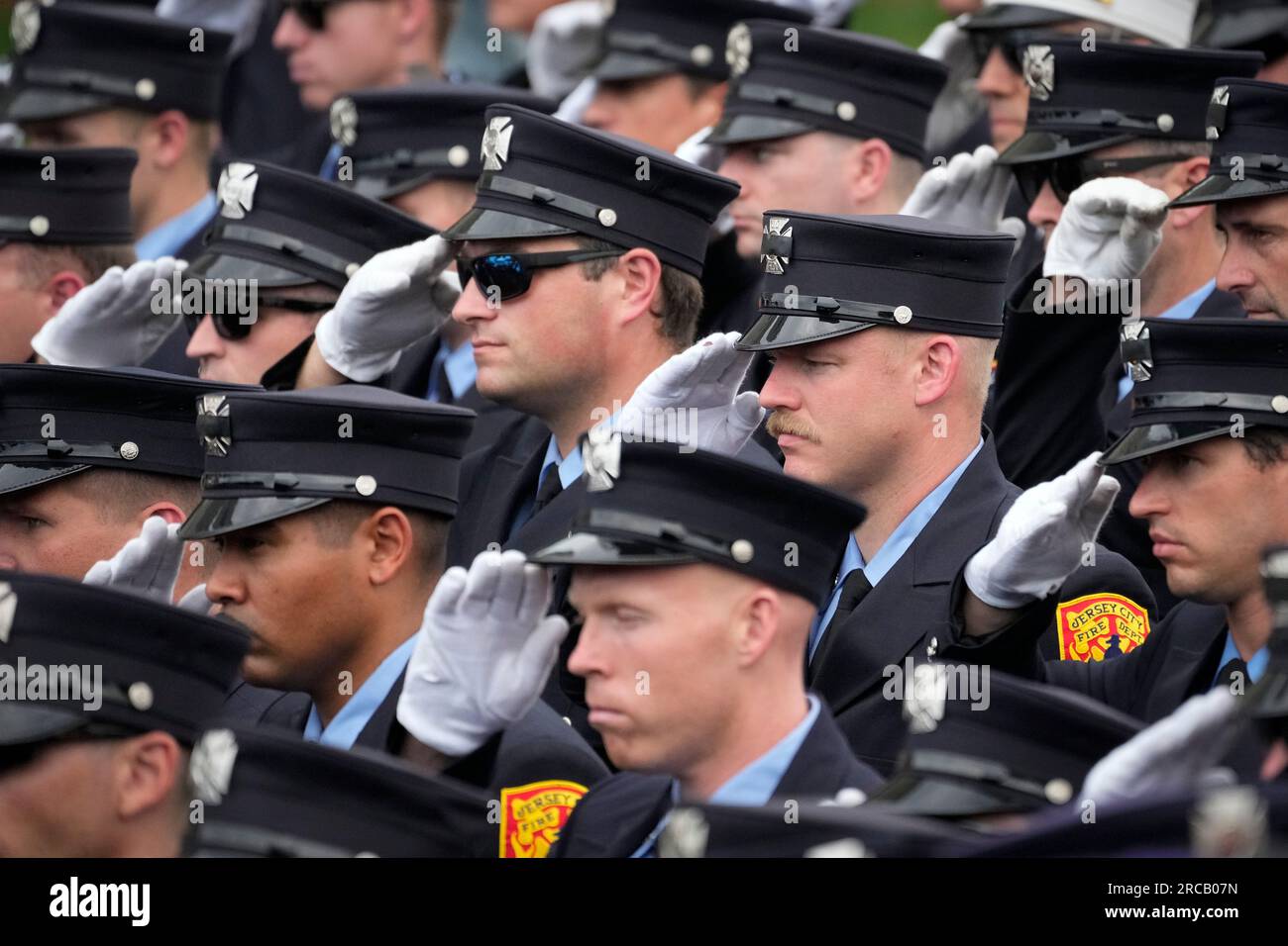 Members of various emergency services salute as the casket of Newark ...