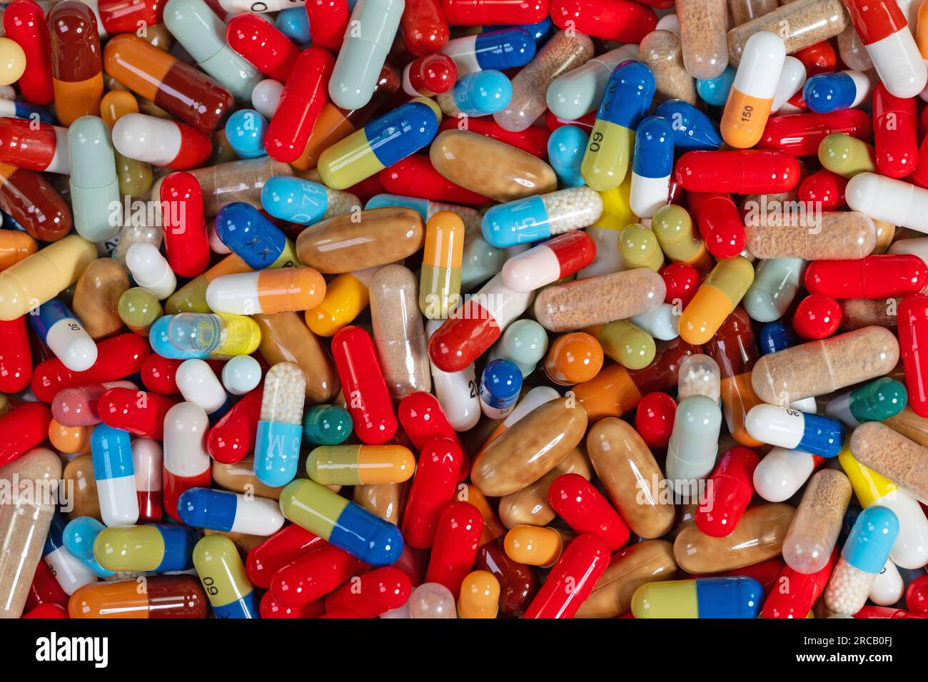 Many colorful capsules and tablets as background Stock Photo - Alamy