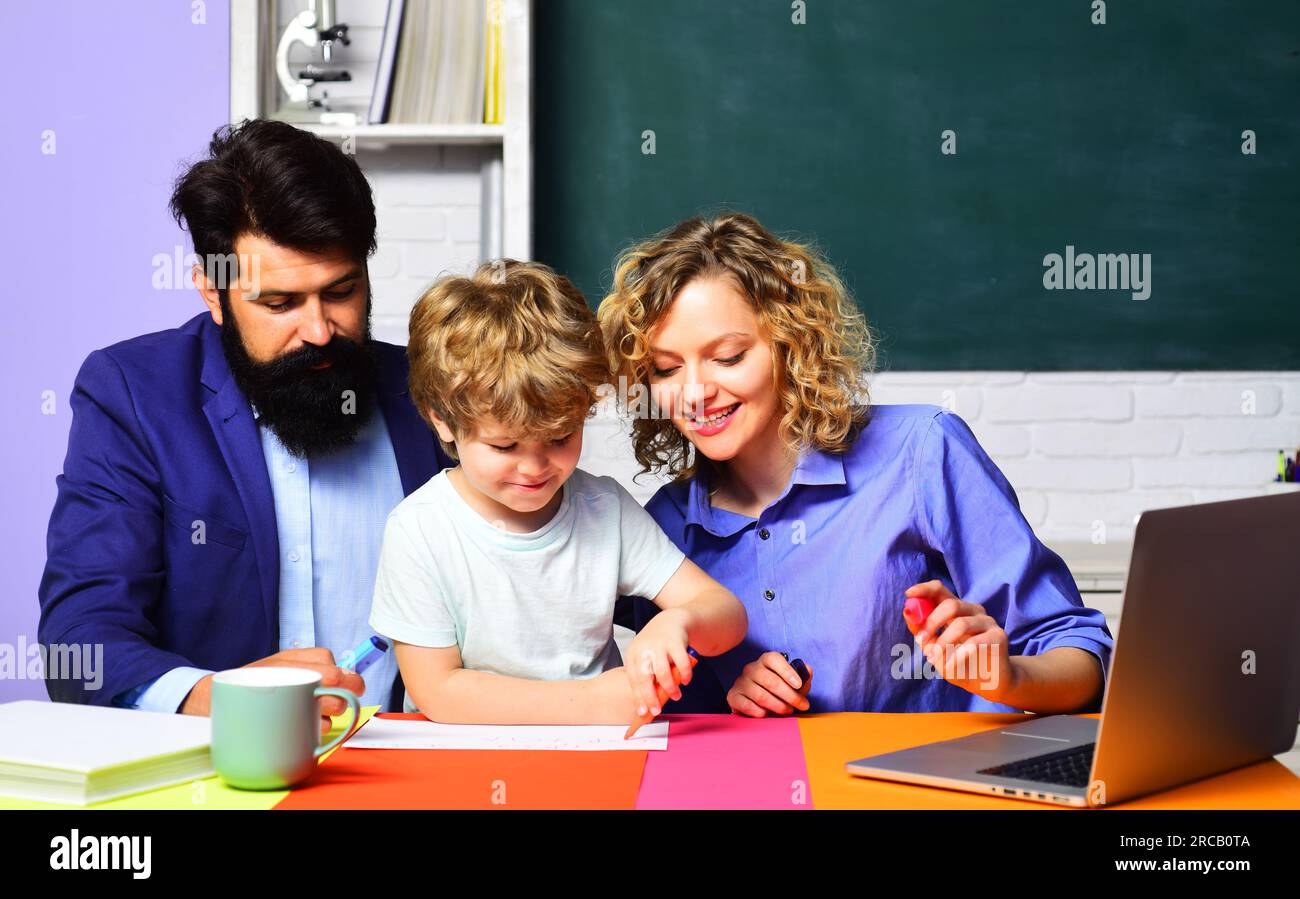 Teachers learning and helping kid in classroom for knowledge studying ...