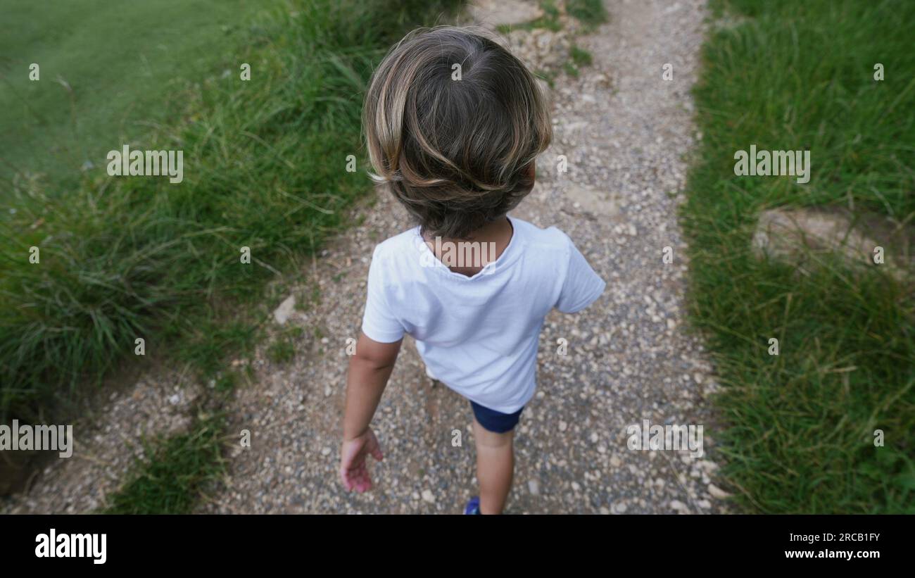 One small boy walking on path from above angle of kid Stock Photo - Alamy