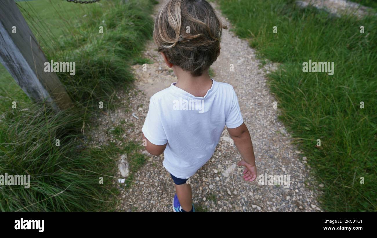 One small boy walking on path from above angle of kid Stock Photo - Alamy