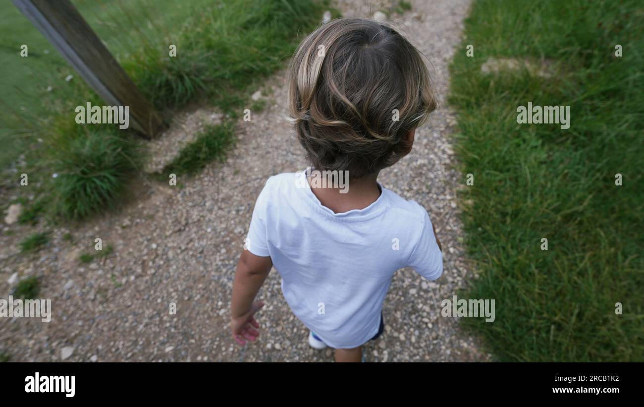 One small boy walking on path from above angle of kid Stock Photo - Alamy