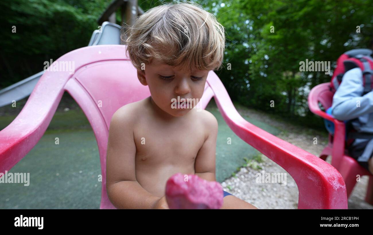 Small kid eating ice cream during hot summer day Stock Photo - Alamy
