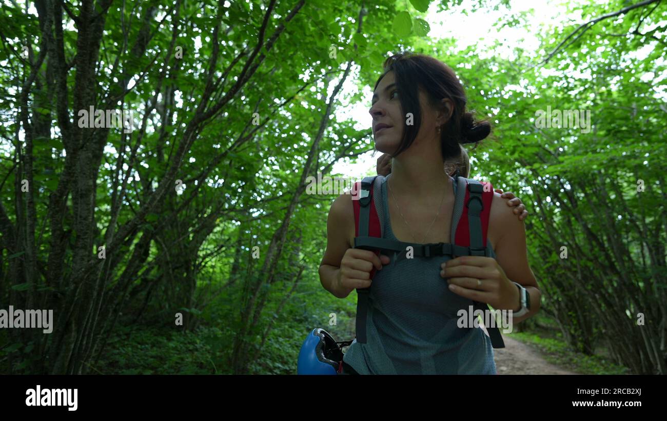 Mother carrying son in backpack carrier mom hiking with child in nature ...