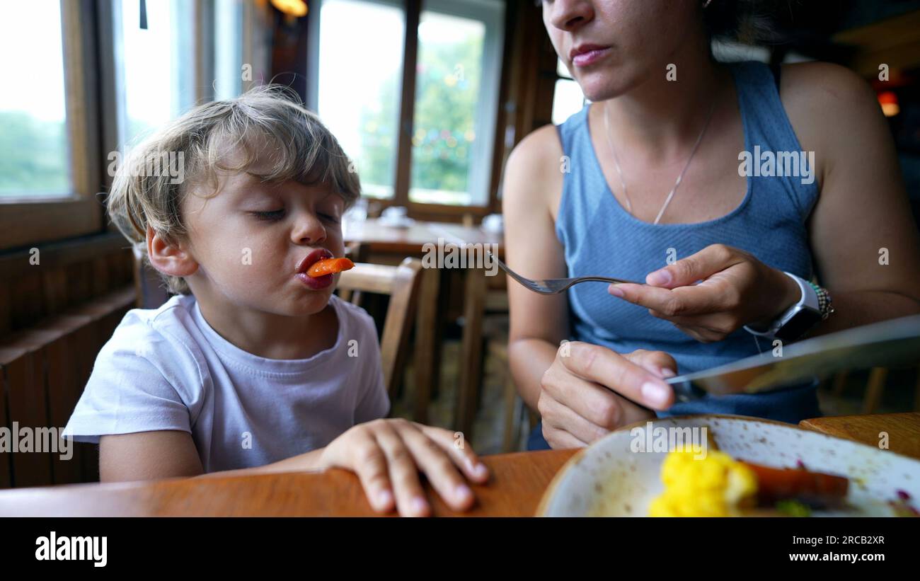 Mother feeding child healthy food mom feed little boy healthy meal ...