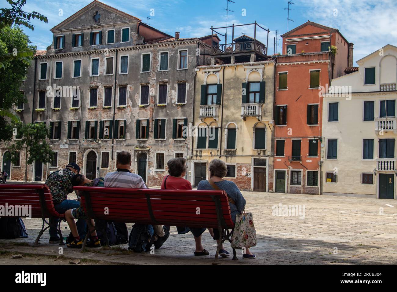 Touristic gondola in narrow grand canal between buildings in Venice ...