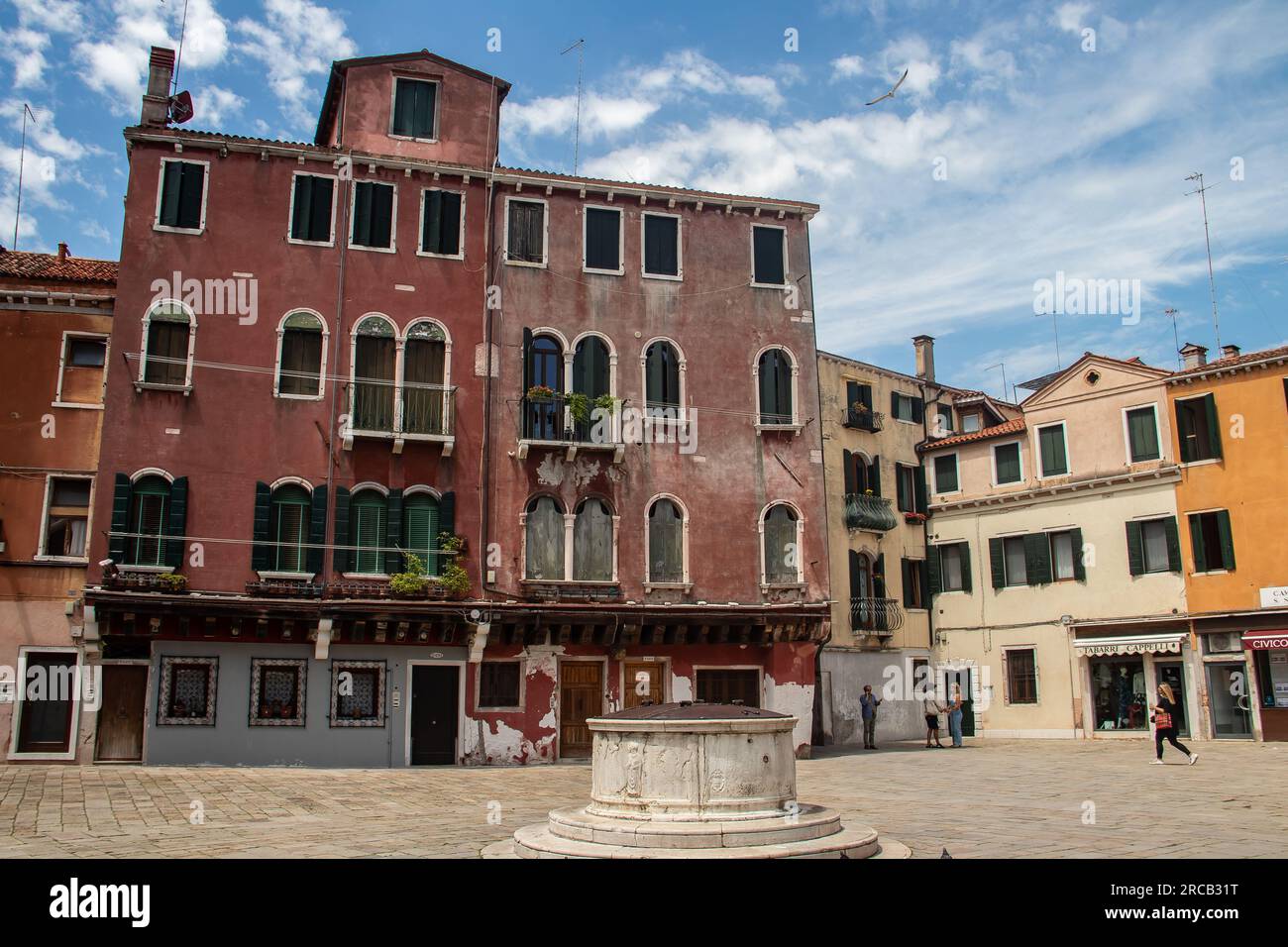 Old typical Venetian building facade in a small Venetian square, Venice ...