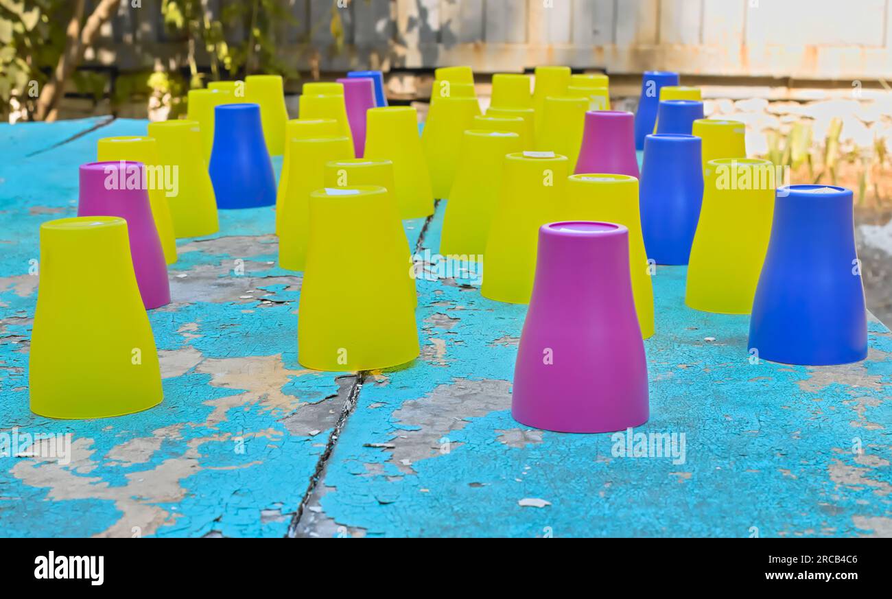 Plastic colored numbered cups turned upside down on a table prepared ...