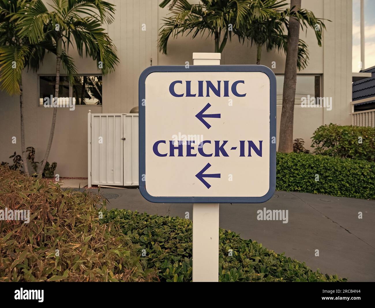 Clinic check-in inscription on sign post. Navigation sign. Wayfinding ...