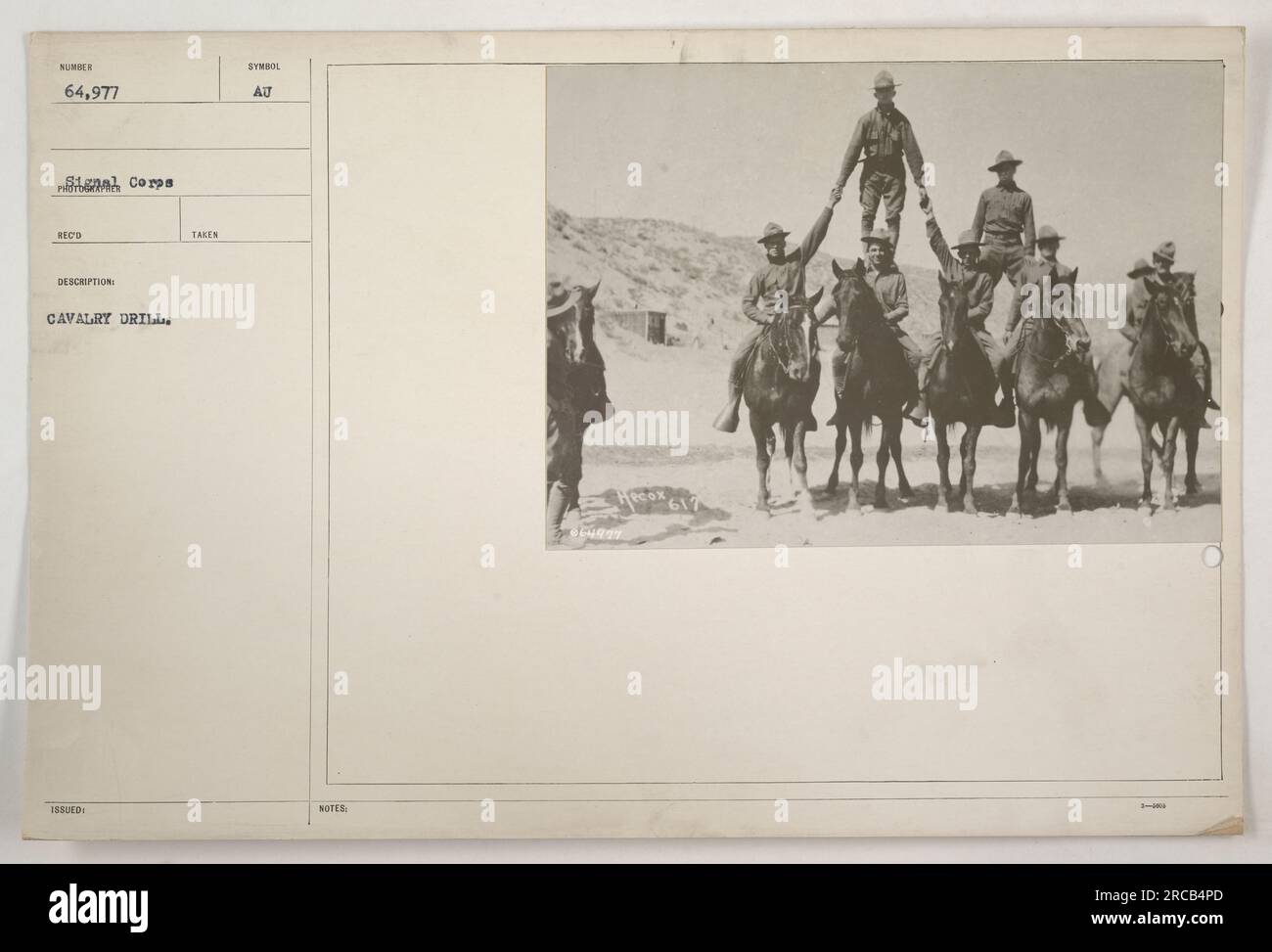 Soldiers participate in a cavalry drill during the 1910s. The image shows a group of mounted ...