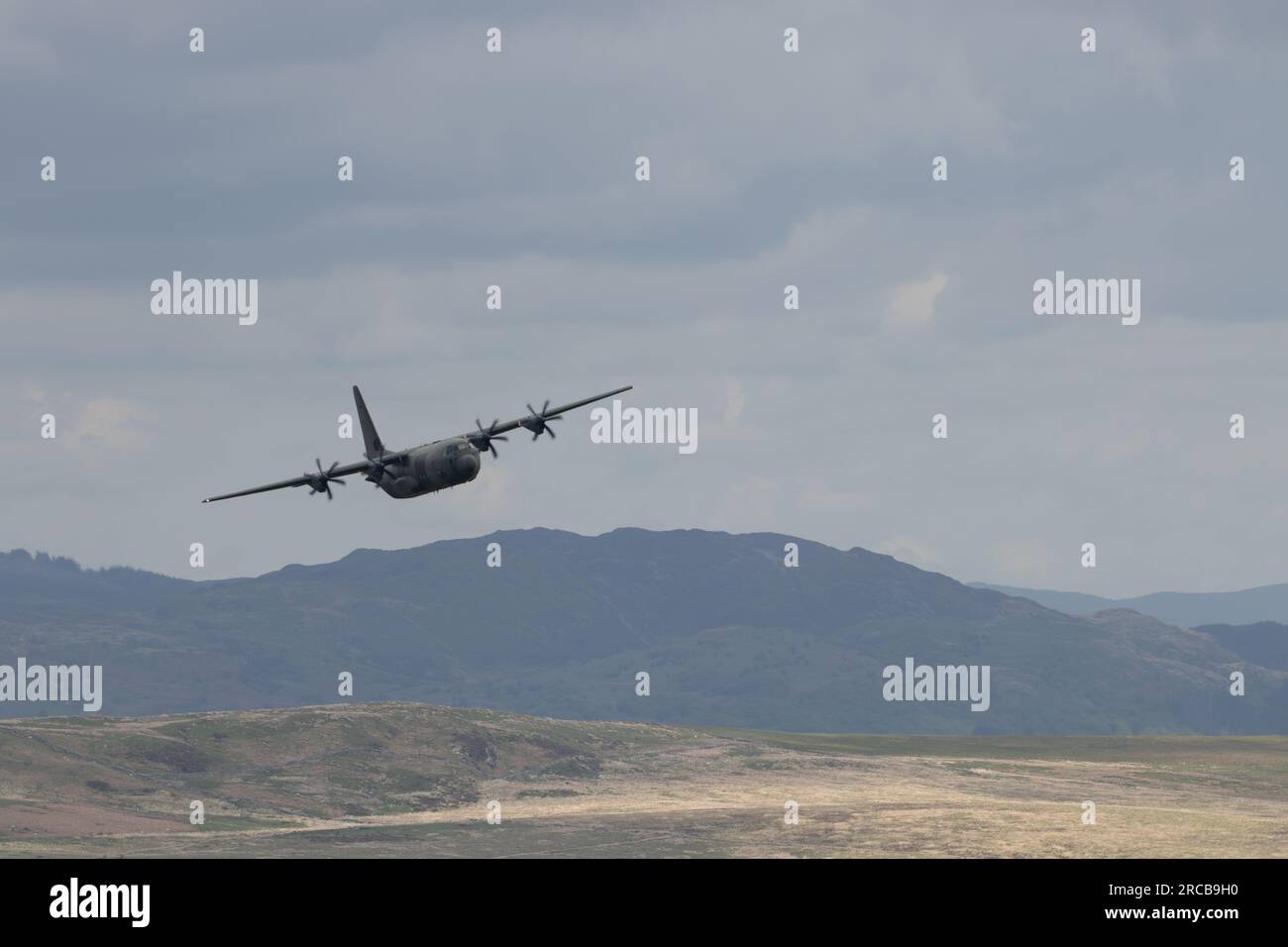 Hercules passing through Mach Loop Stock Photo - Alamy