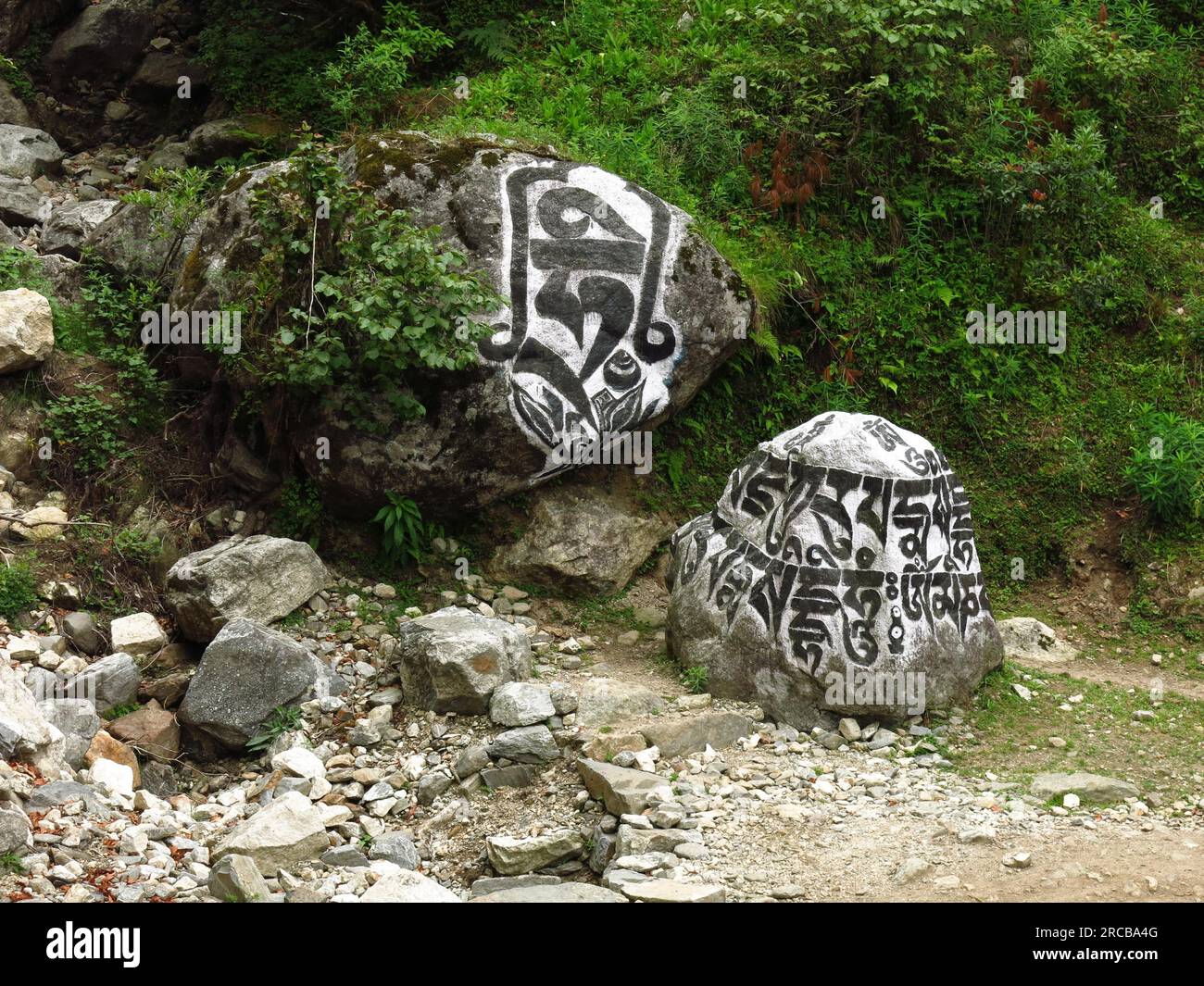 Big mani stones, boulder with engraved buddhist mantra Stock Photo - Alamy
