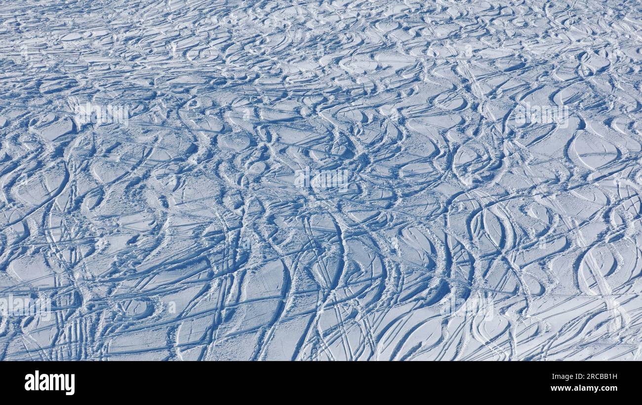 Winter background. Ski and snowboard tracks in powder snow Stock Photo ...