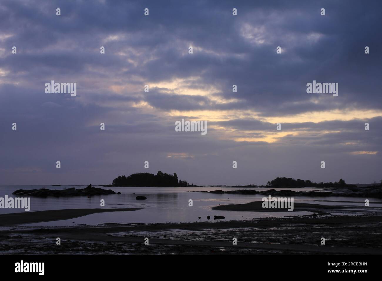 Sunlight pushing trough thick clouds morning at the shore of Lake ...