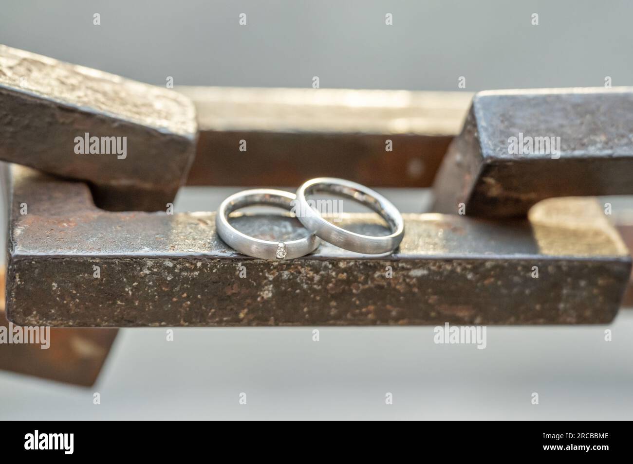 Two hands with wedding rings rest on a strong anchor chain Stock Photo ...