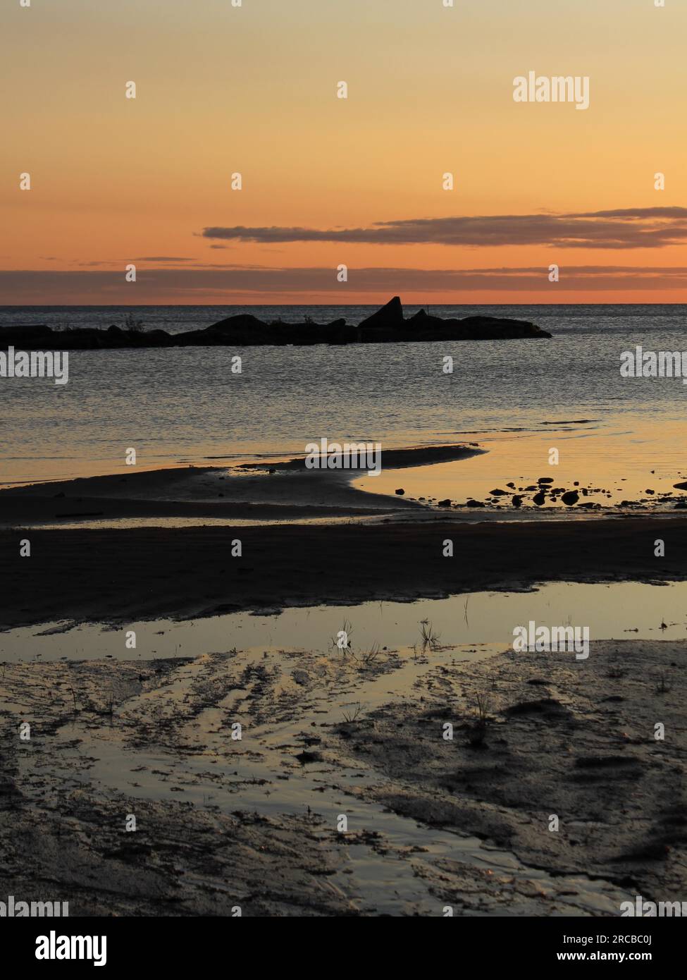 Sand beach shaped by the water at sunrise. Summer scene in Vita Sannar ...