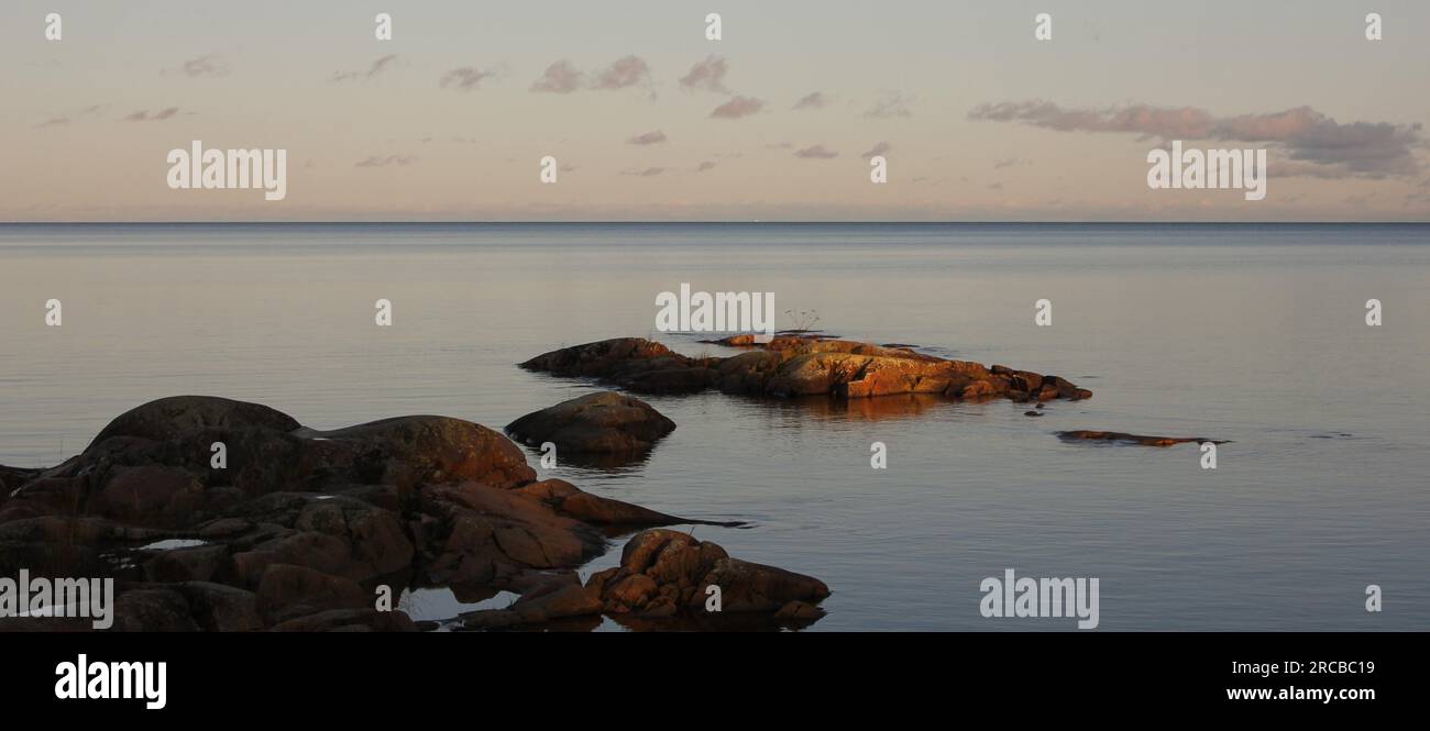 Last sun light of the day touching a rock formation at Lake Vanern ...