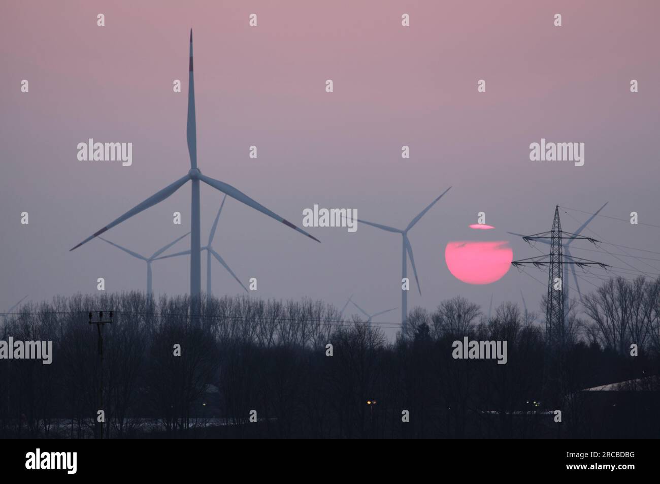 Wind turbines and setting winter sun hi-res stock photography and ...