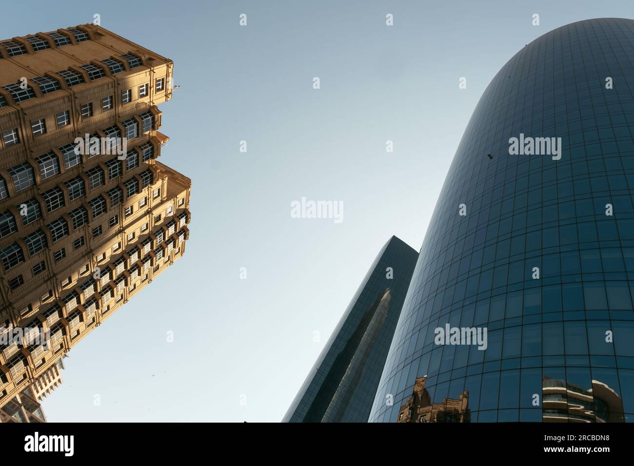 Baku, Azerbaijan - June 26, 2023: A cylindrical skyscraper's mirrored ...