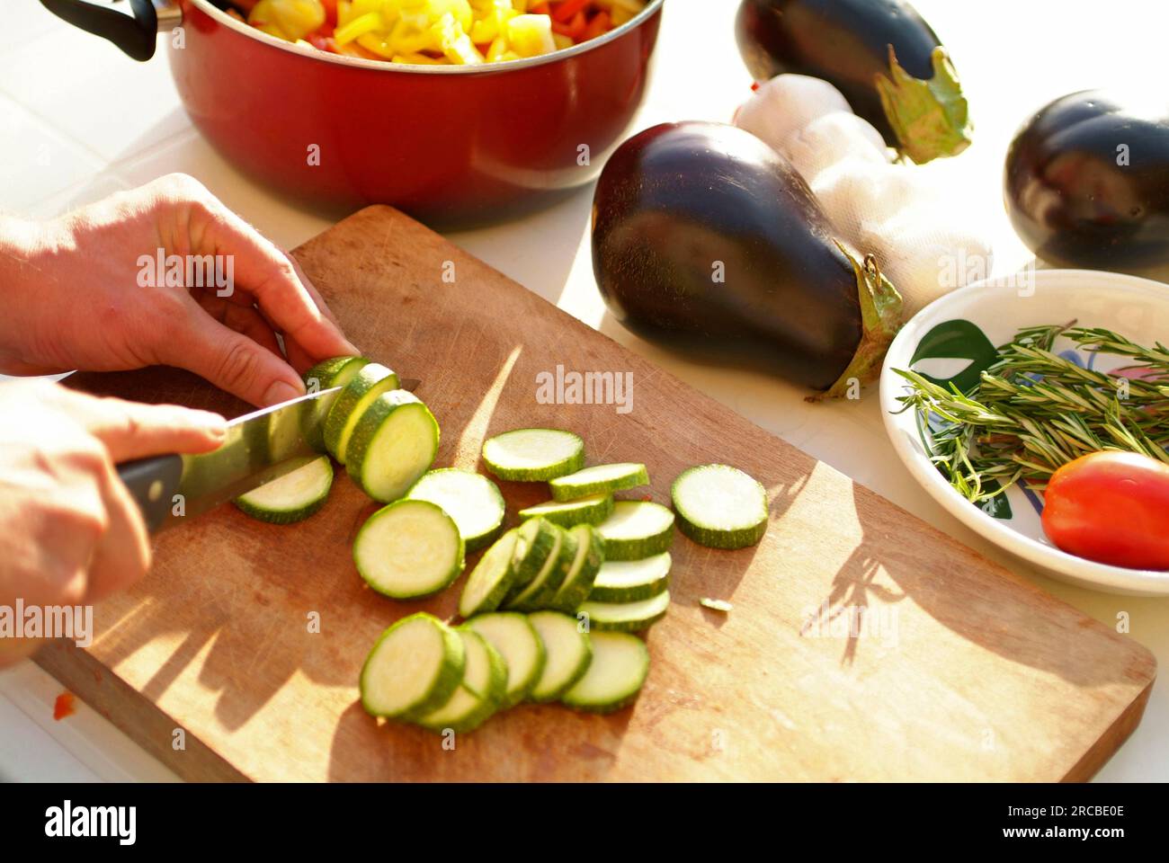 Cutting zucchini with knife, slices, eggplant Stock Photo - Alamy
