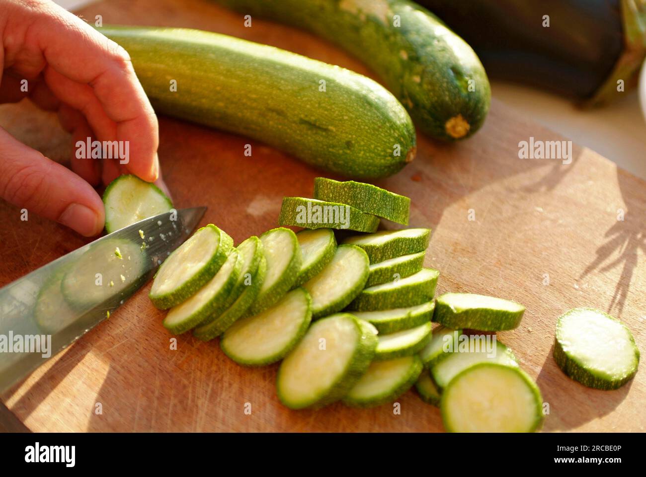 Zucchini cutting with knife, slices Stock Photo - Alamy