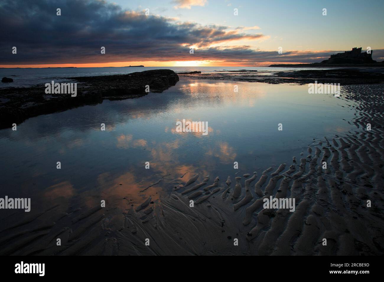 Low tide, Bamburgh Castle, Northumberland national park, England ...