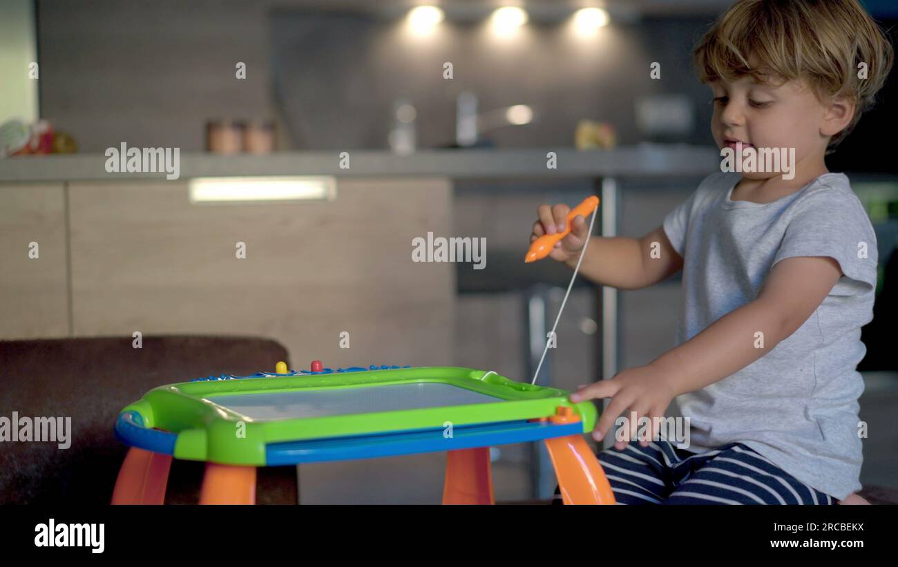 Child plays with drawing board becoming agitated and frustrated ADHD ...