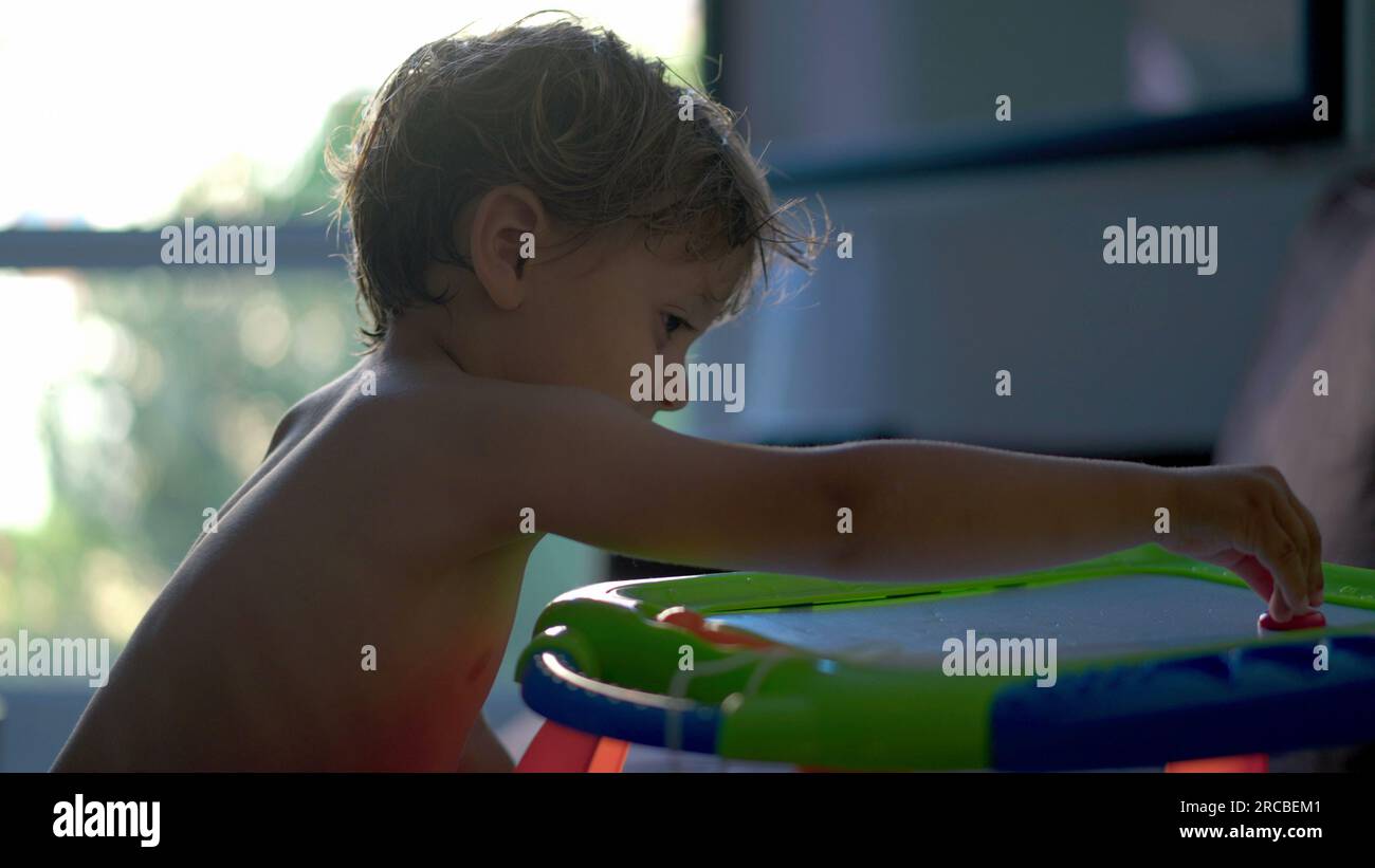 Child plays with drawing board becoming agitated and frustrated ADHD ...