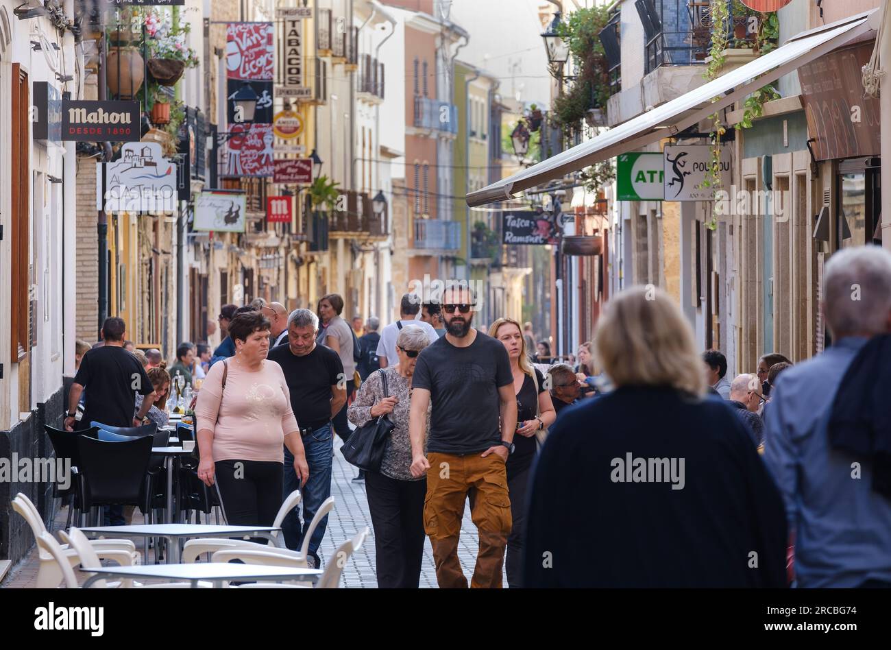 Street with many restaurants and shops in the old town of Denia Stock ...