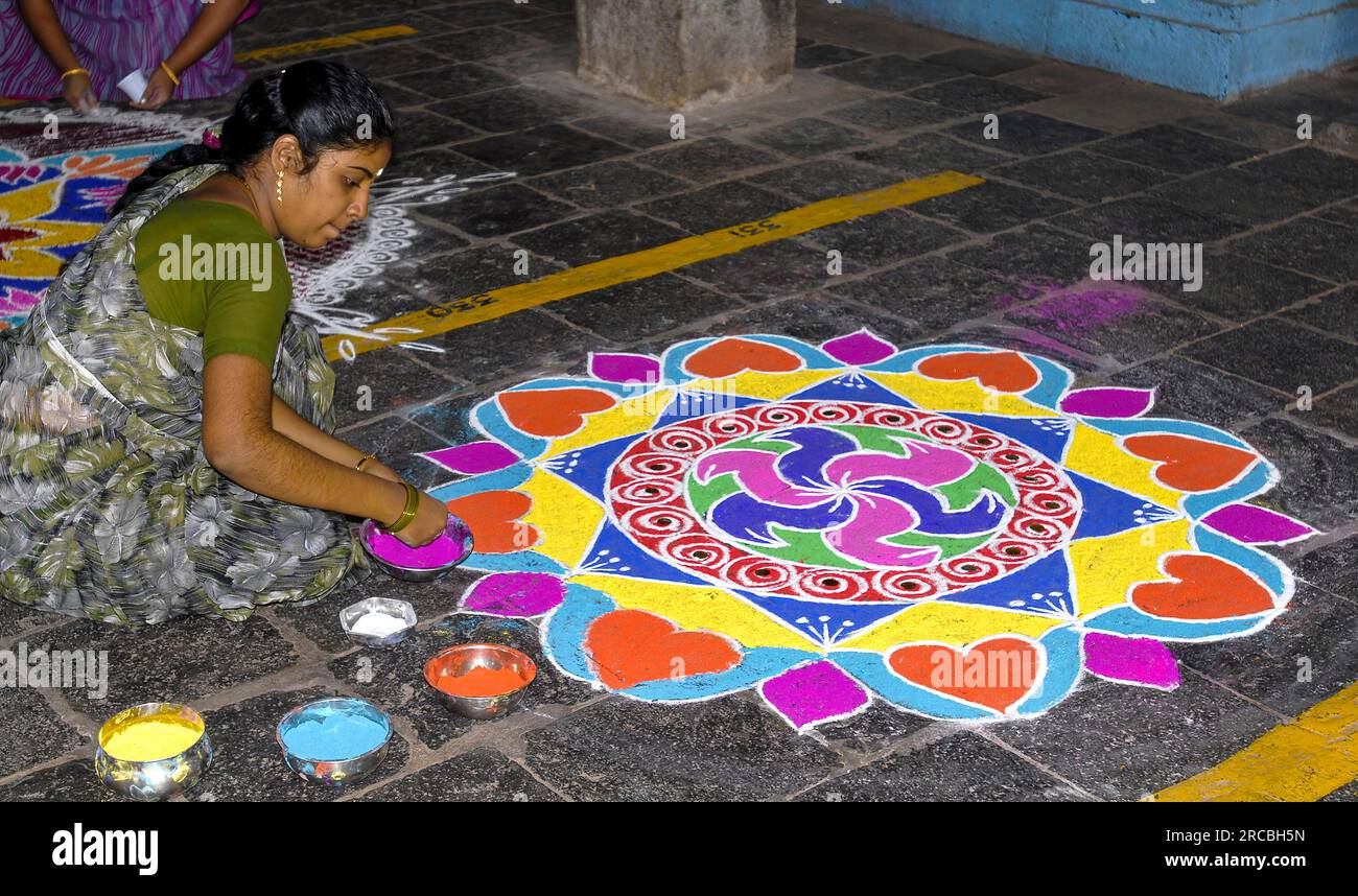 Drawing kolam, rangoli inside the temple floor, Sri Neelayadhakshi ...